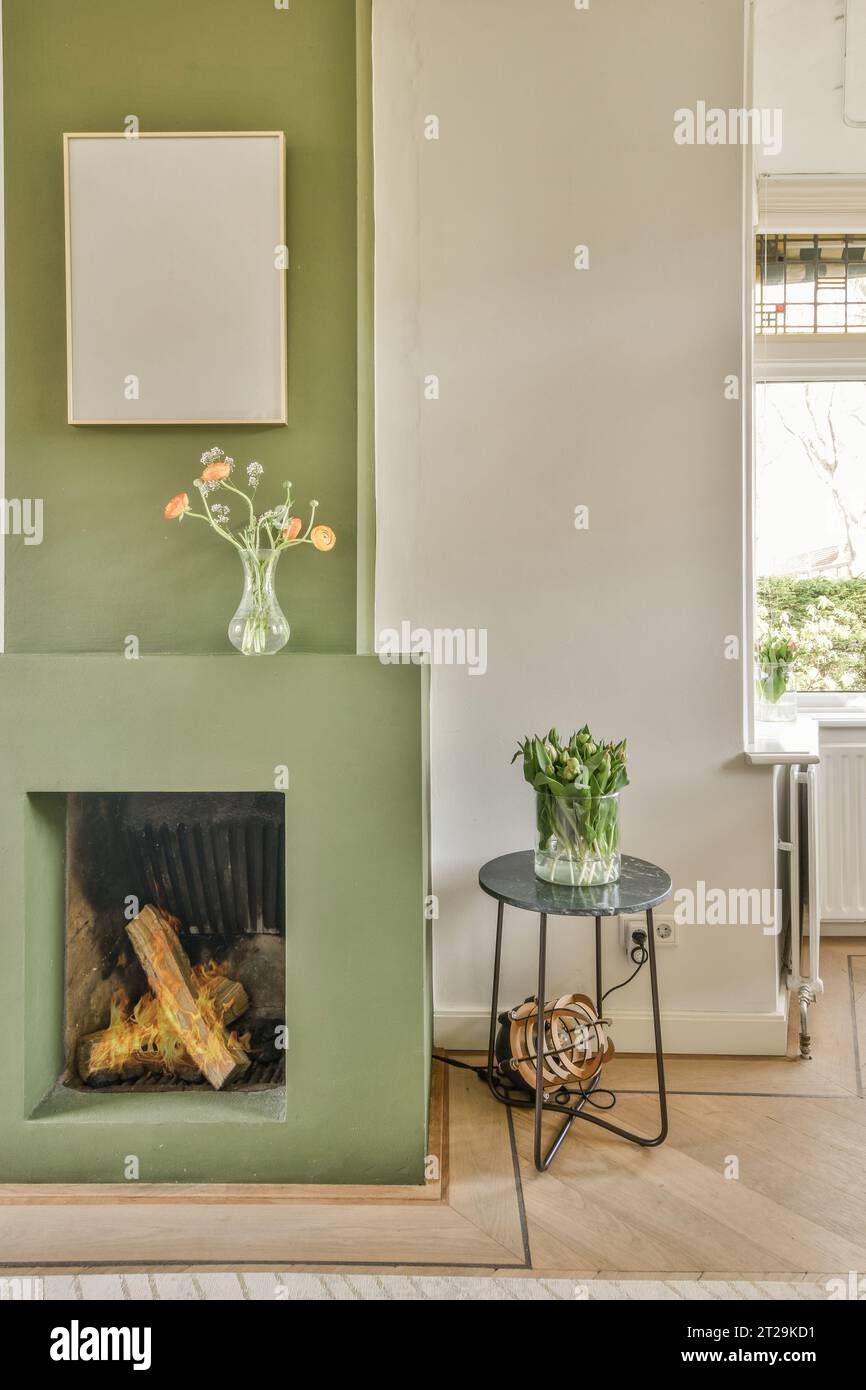 Flower vases on mantle over fireplace and table with picture frame ...