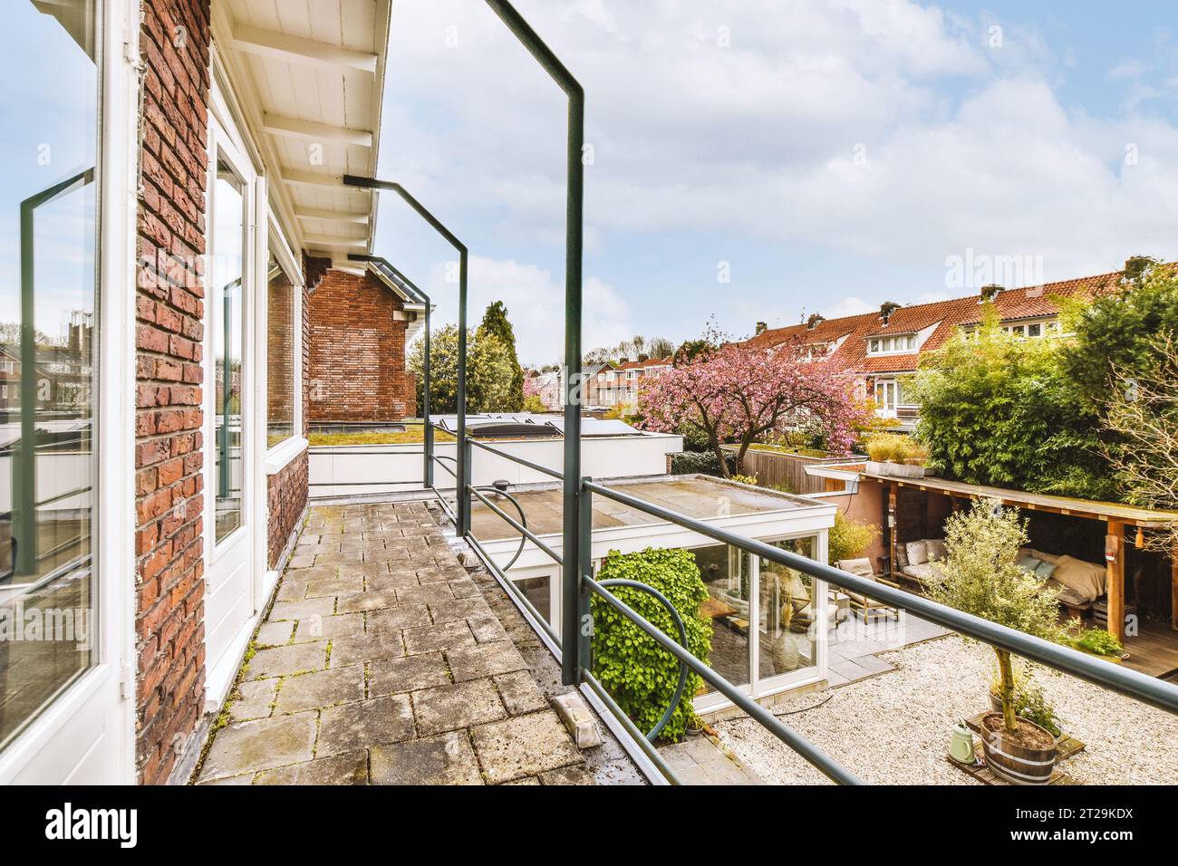 Empty balcony with brick wall and doors against residential building ...