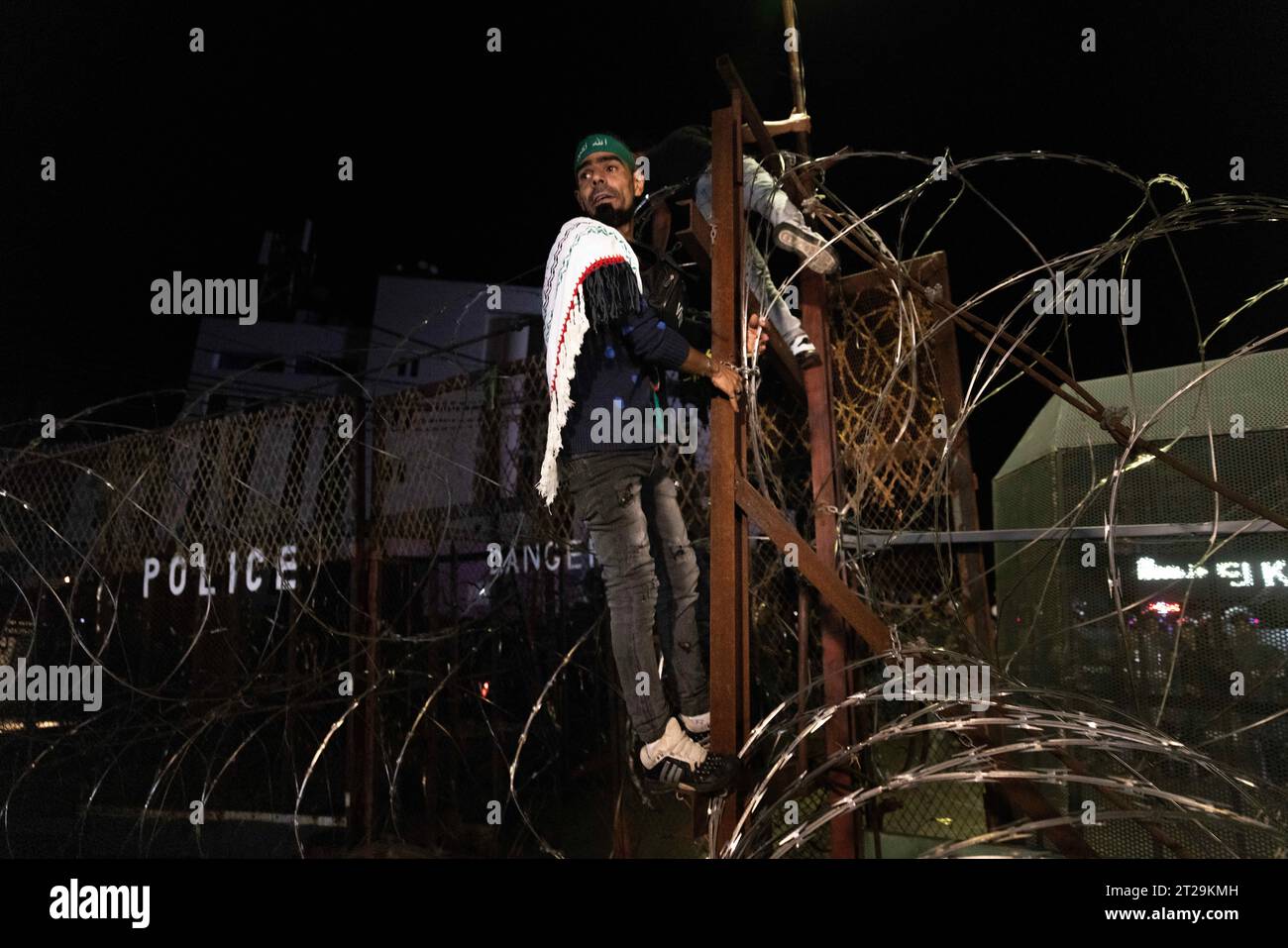 Awkar, Lebanon. 18th Oct, 2023. Demonstrators climbing a barrier to ...