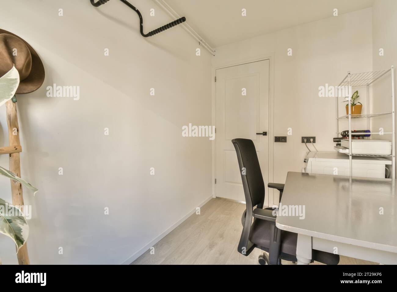 Interior of small home office with clean desk and empty chair with ...