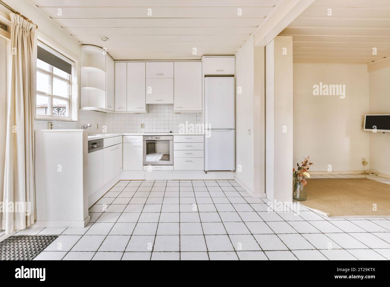 Empty open plan kitchen with white cabinets and countertop and ...