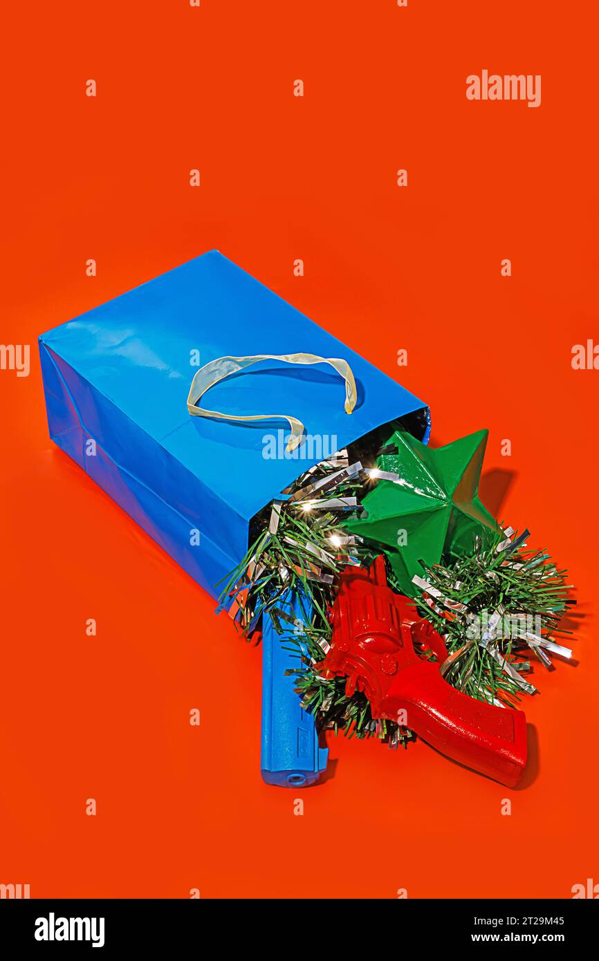 High angle of blue carton bag placed on red surface with tinsel ...
