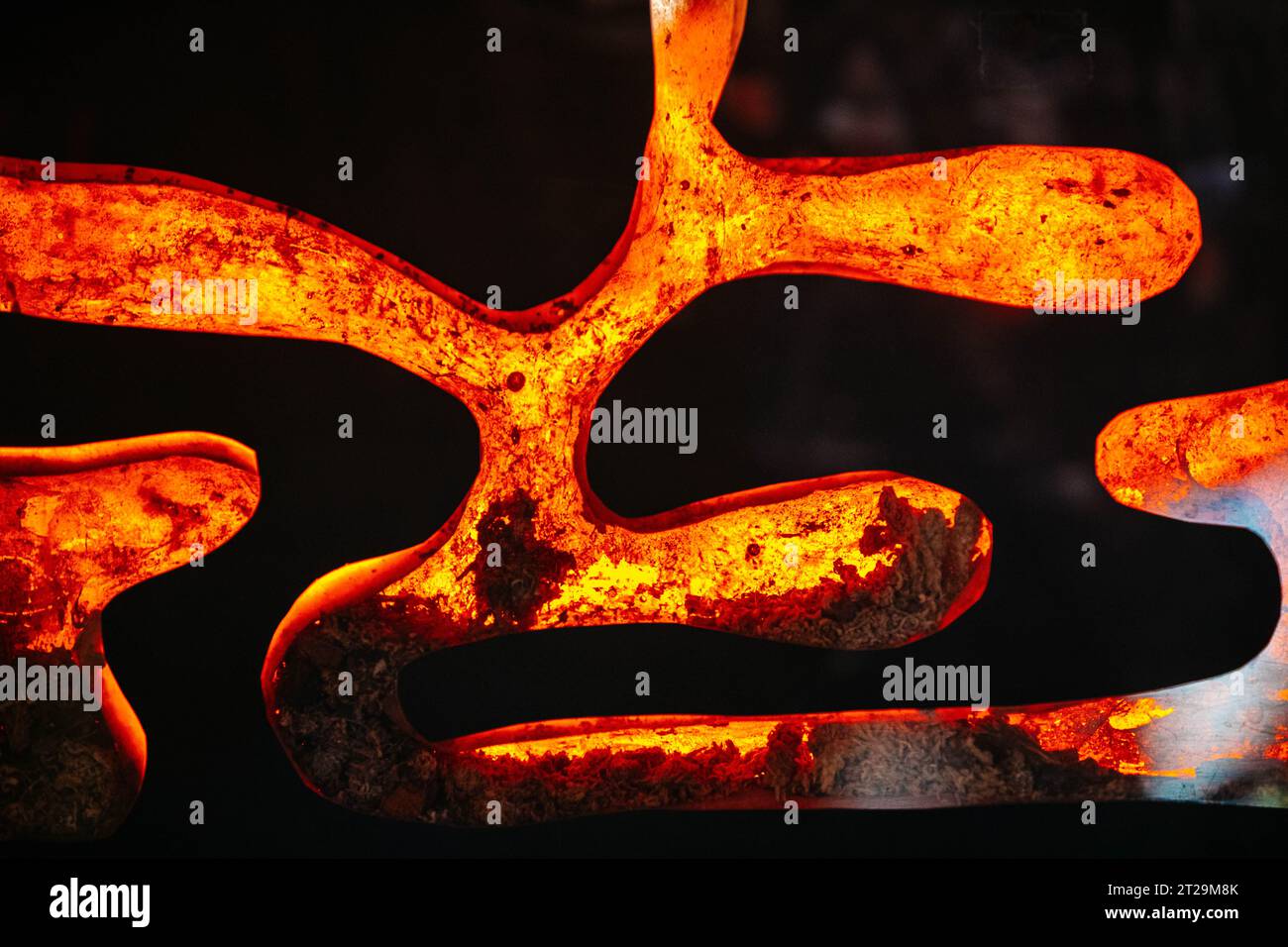 Abstract full frame background of red hot metal forming curvy fiery ...