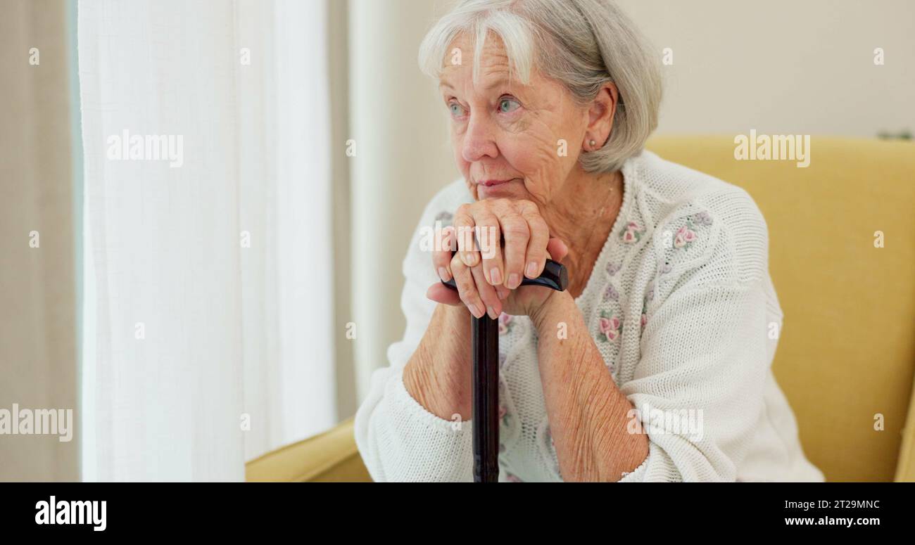 Senior woman, cane and thinking on home sofa to remember memory and relax in retirement. Serious ...