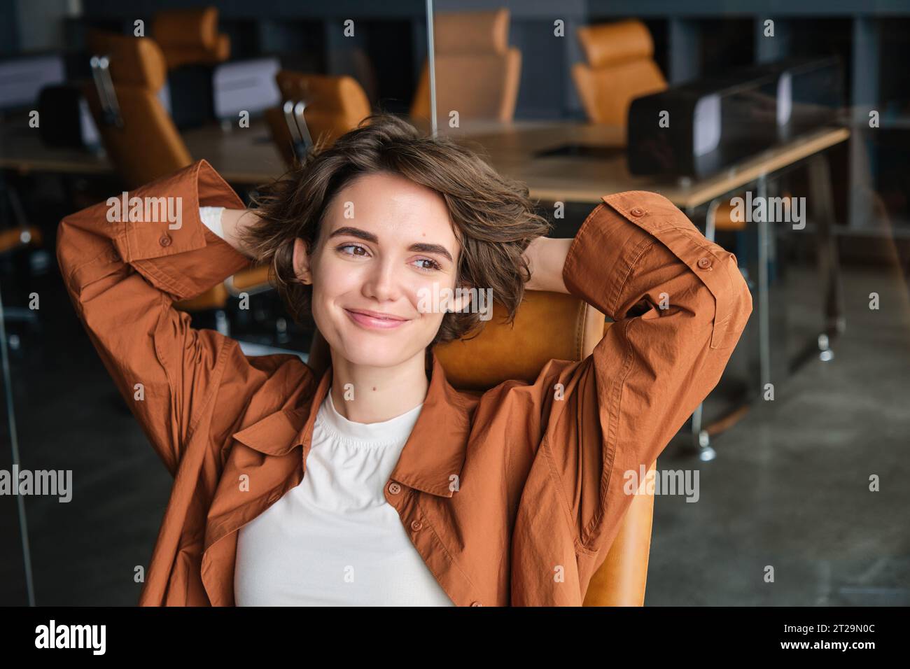 Close up portrait of woman at workplace, digital nomad sits back and ...
