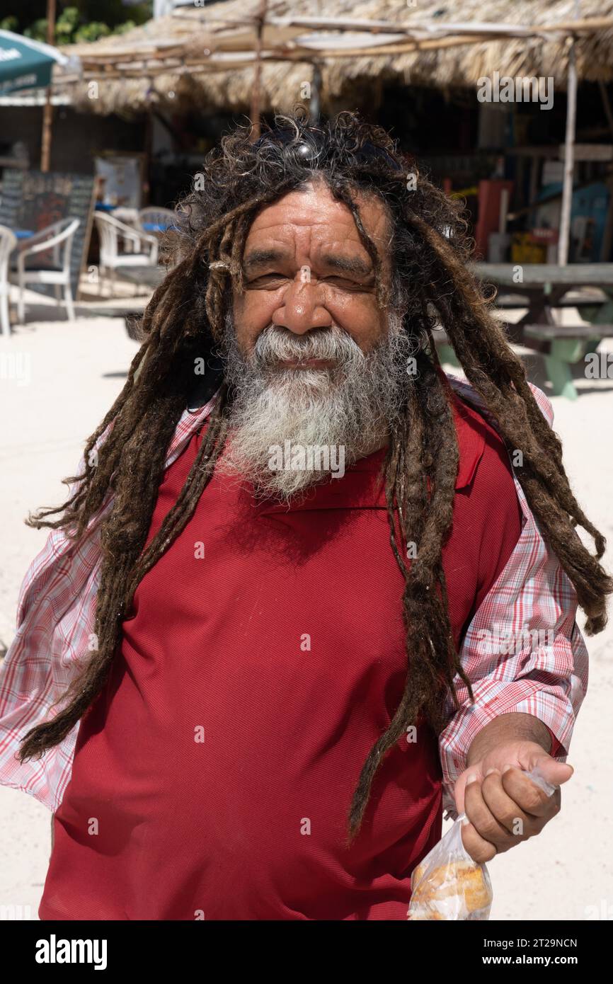 An older Belizean man with a beard and dreadlocks on the beach in San ...