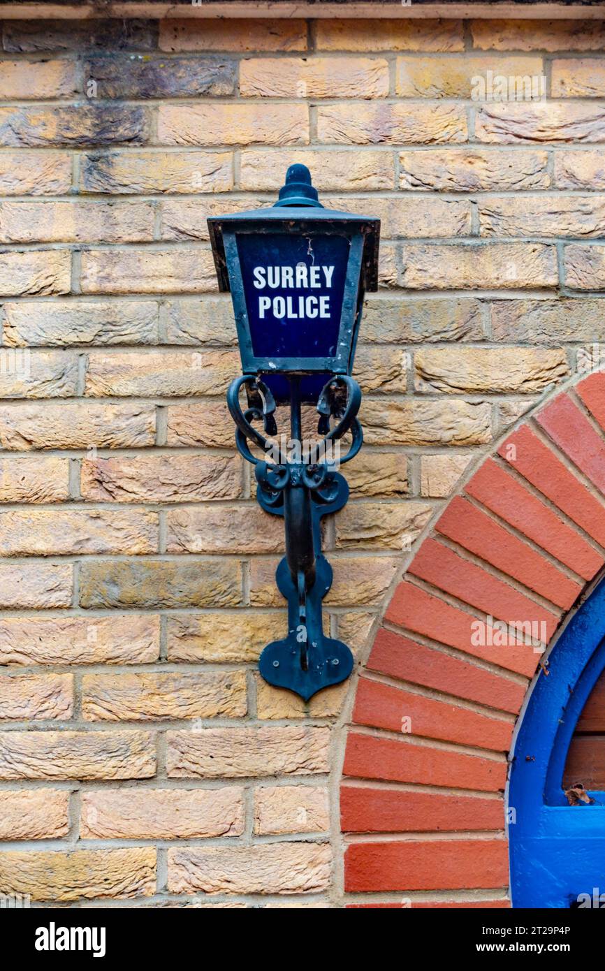 A blue lamp bearing the words 'surrey police' on the wall of the police ...