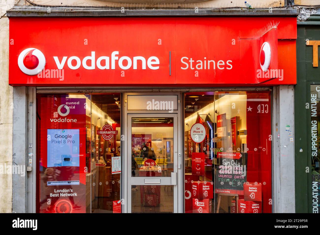 The Vodafone shop with it's iconic red branding on The high Street in ...