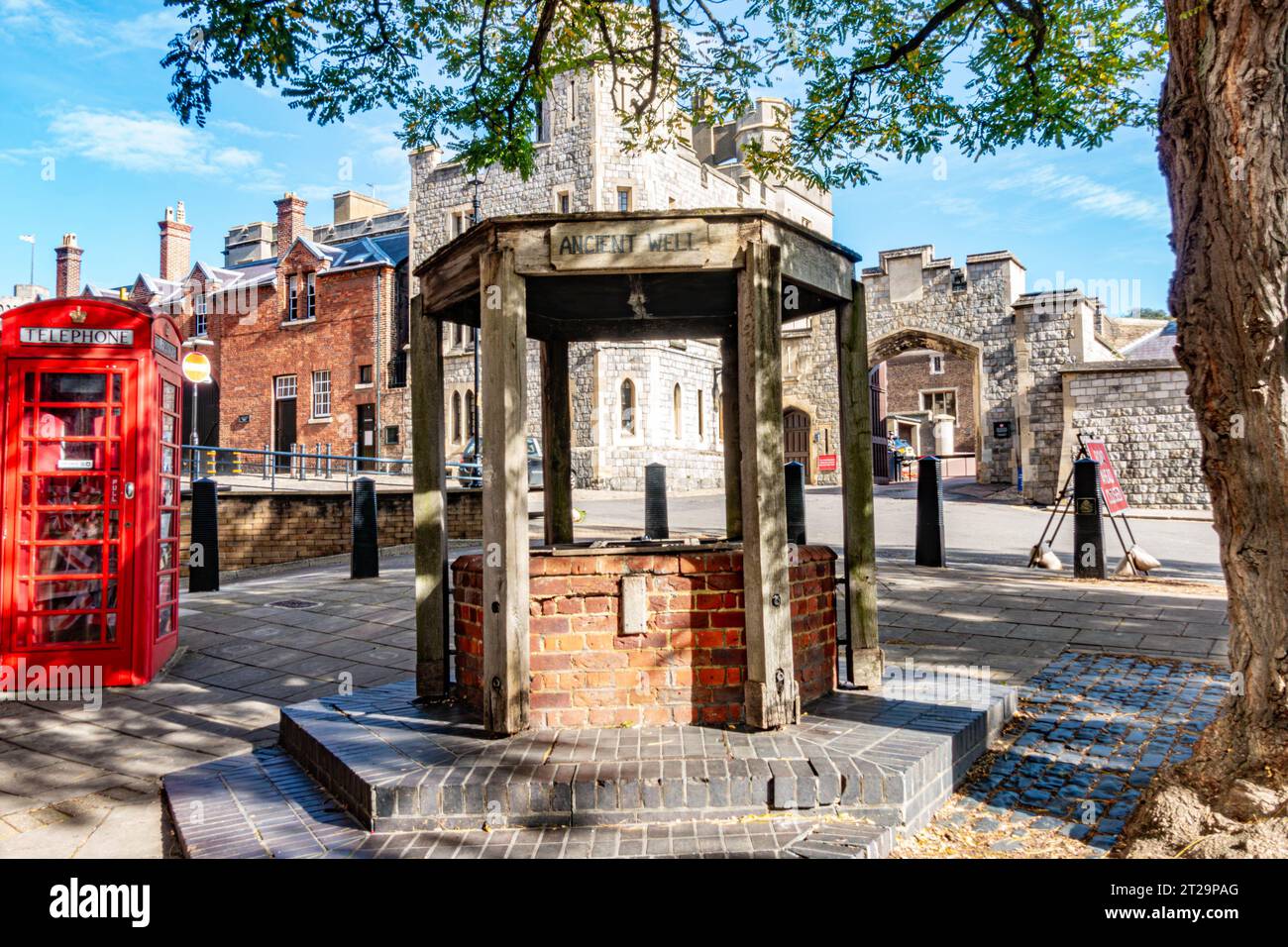 An old ancient well and red telephone box stand outside Windsor Castle ...