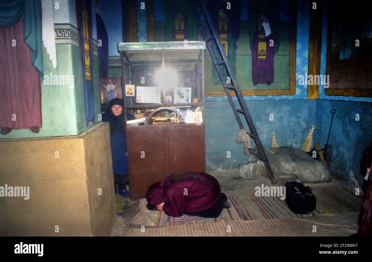 Borănești, Ialomita County, Romania, approx. 2000. Woman praying on her ...
