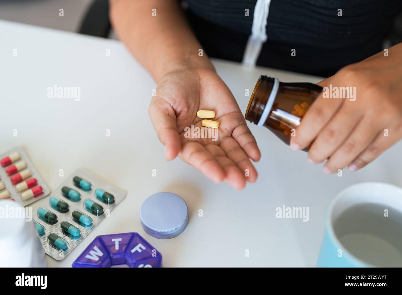 Sick illness woman hold two pill on hand pouring capsules from ...