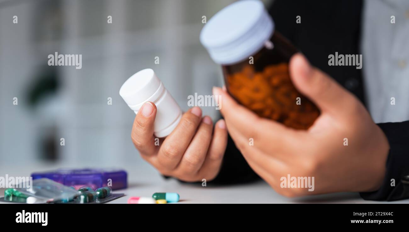 Woman hold bottle of drug tablet painkiller or vitamin supplement ...
