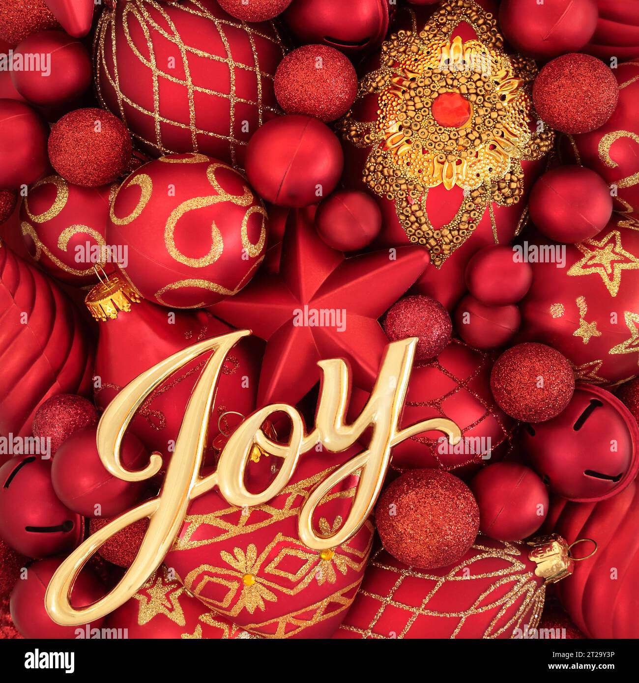 Christmas Joy sign with red gold bauble decorations abstract background ...