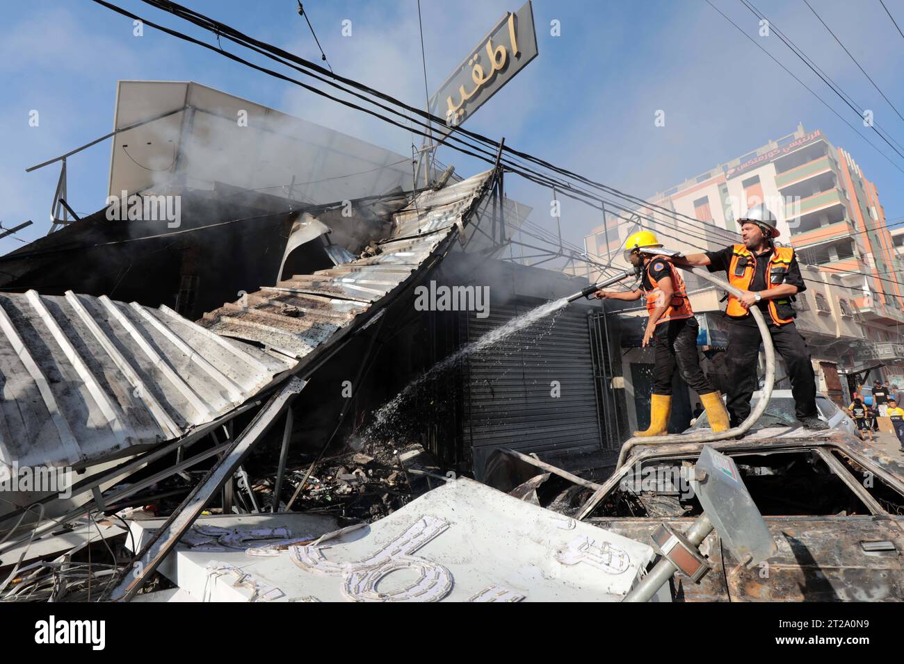 Palestinians and civil defense inspect a destroyed bakery after an ...