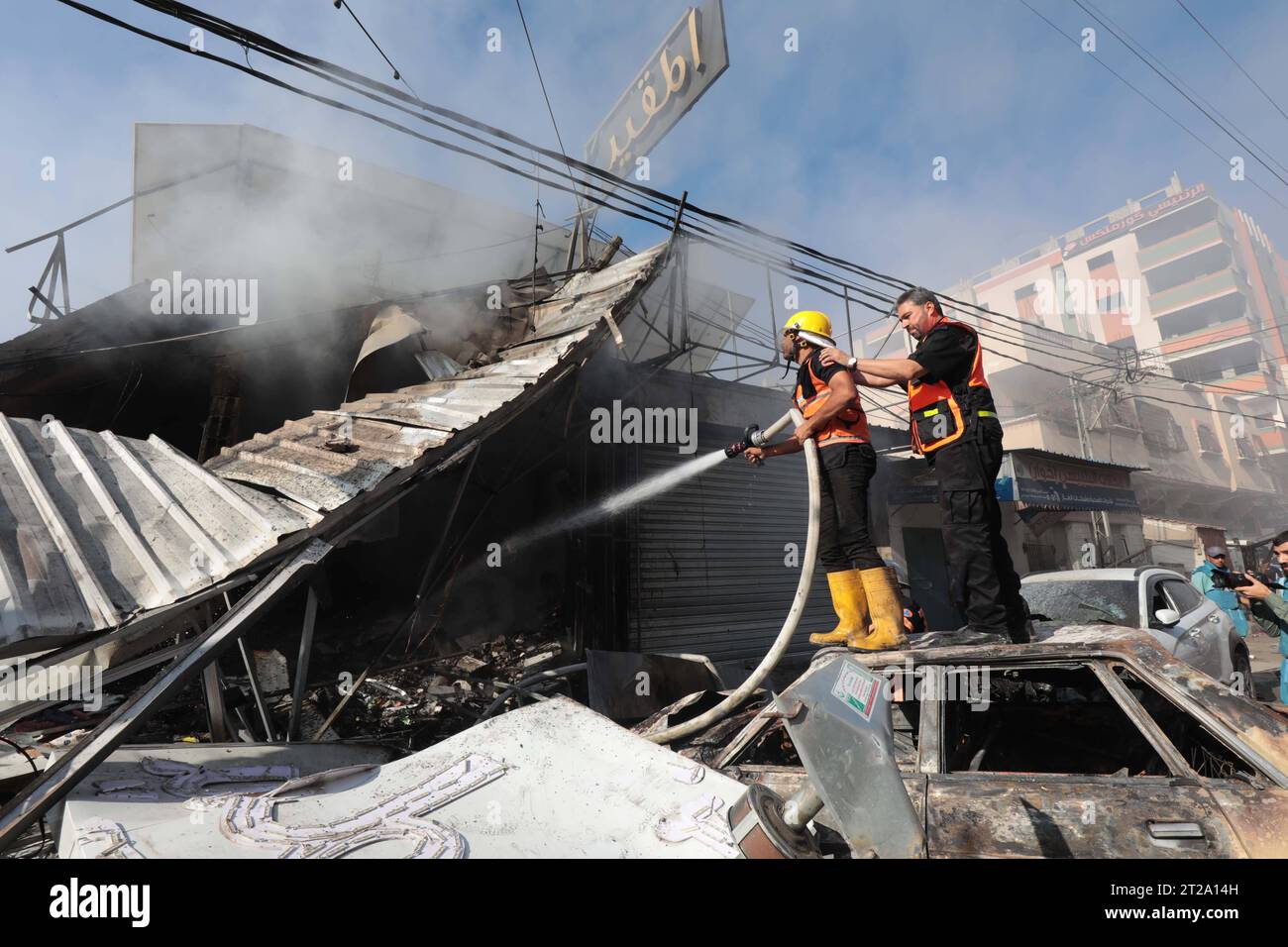 Palestinians and civil defense inspect a destroyed bakery after an ...