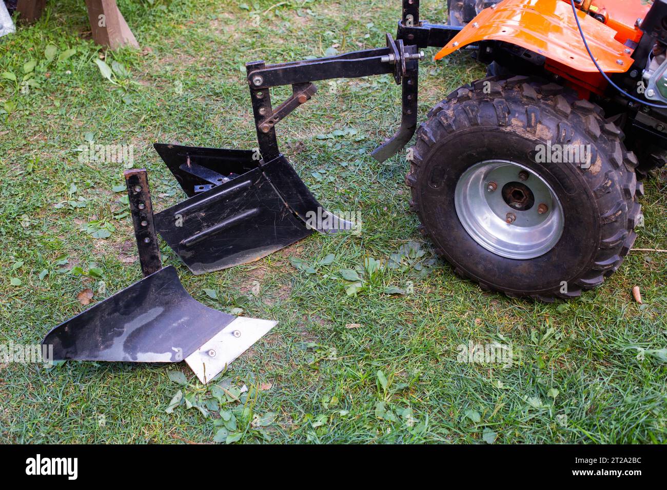 Plow and hiller complete with a walk-behind tractor for agricultural ...
