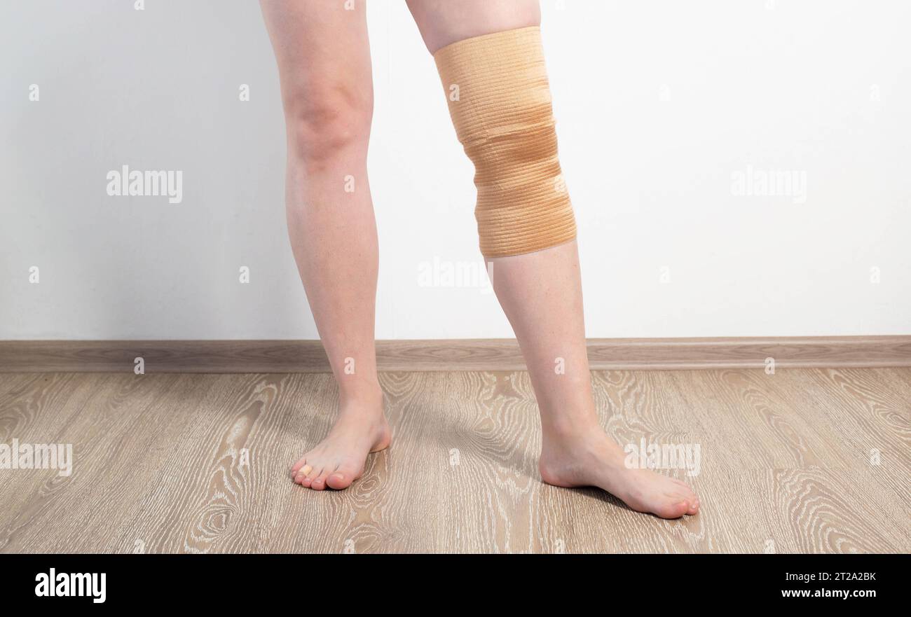 Orthopedic medical kneecap on the leg of a girl. Fixation and support ...