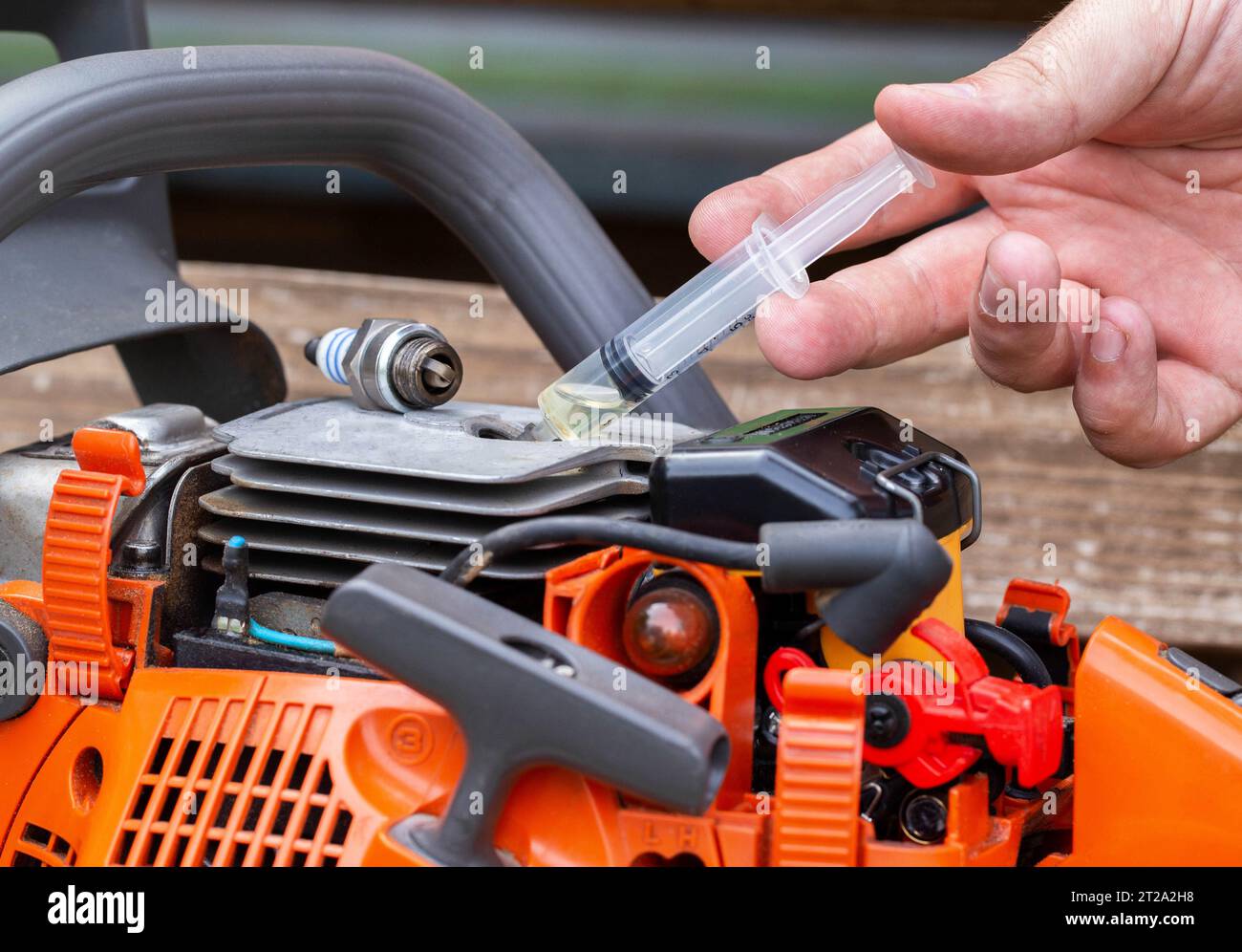 Injection of fuel from a syringe into the combustion chamber of a ...