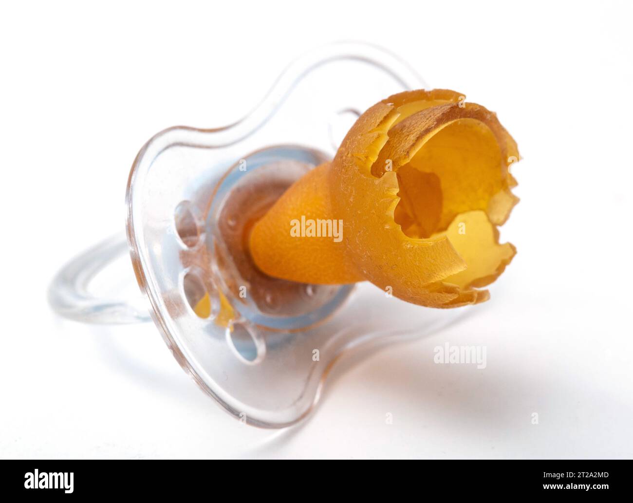 A chewed silicone pacifier on a white background, close-up. Poor ...