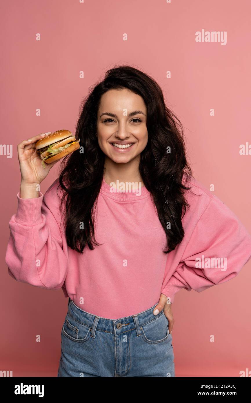 Young pretty brunette with a radiant smile showing her favorite ...