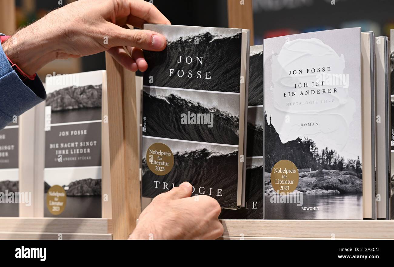 18 October 2023, Hesse, Frankfurt/Main: A hand reaches for a book by ...