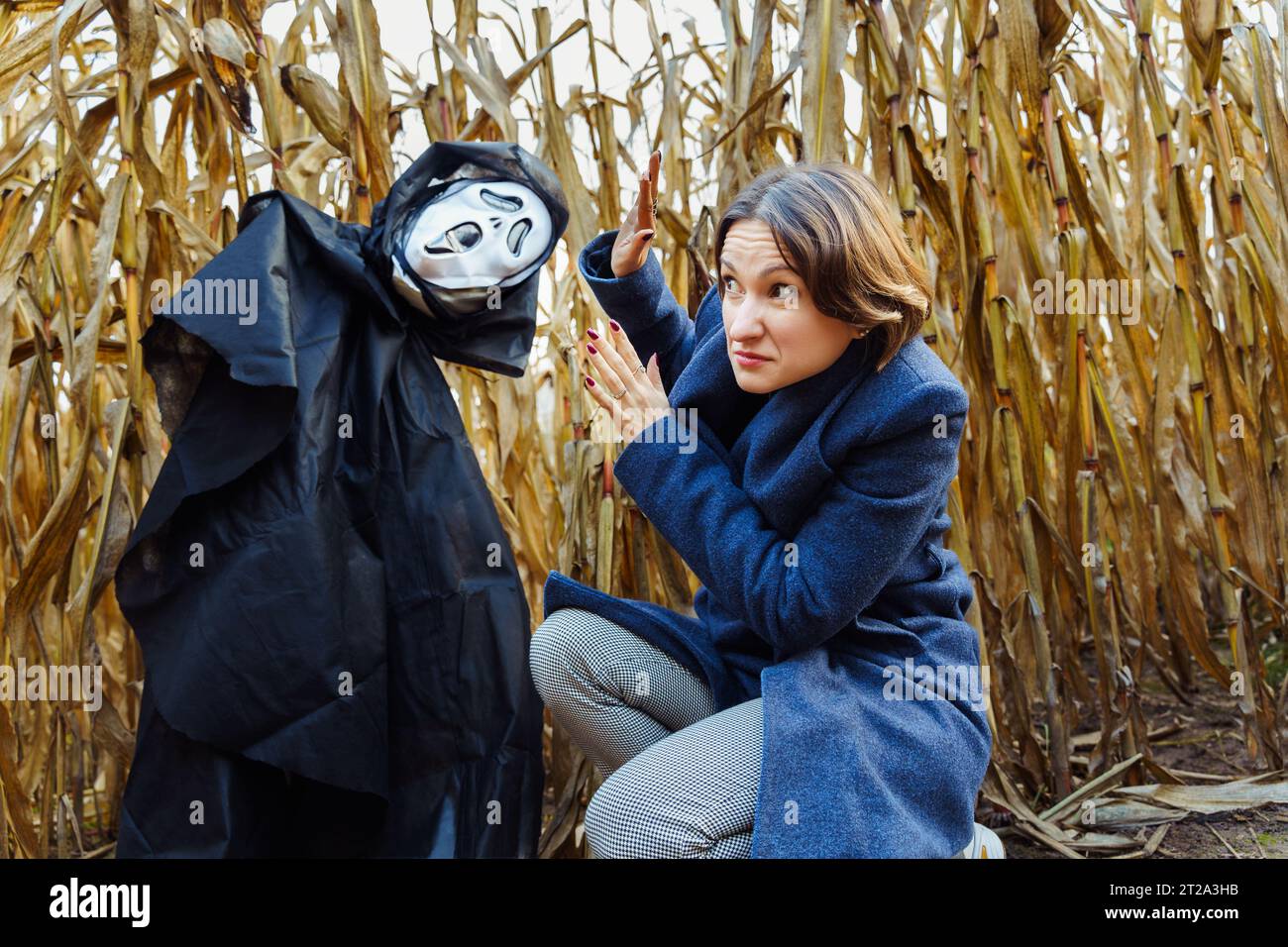 Woman Close Up With Hands Next To Creepy Scarecrow With Mask Of Death ...