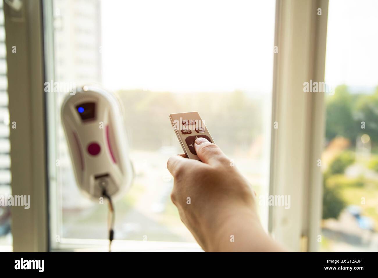 Remote control of a robotic window washer that washes glass from dirt ...