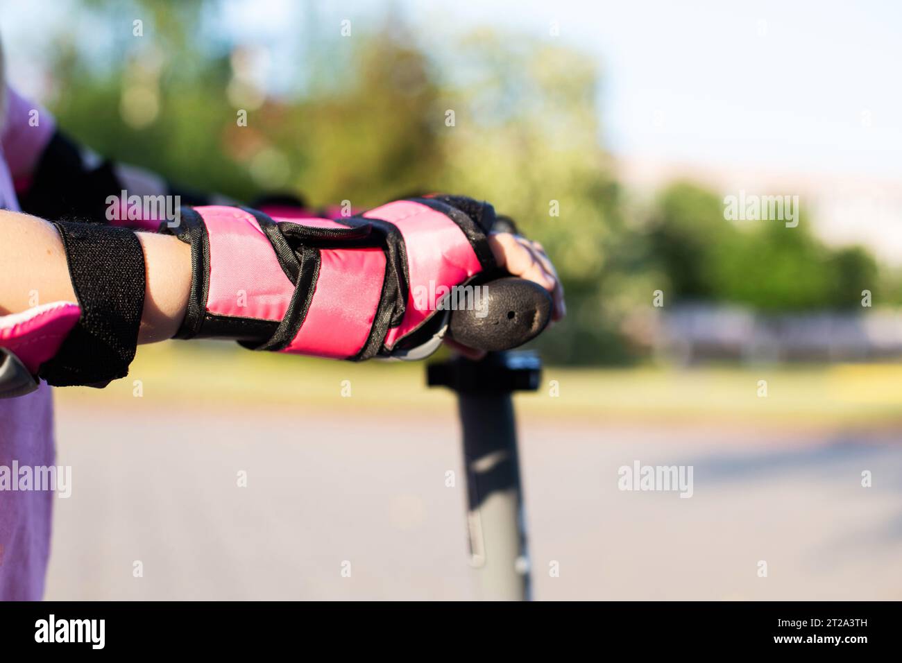 The girl's hand in a protective oversleeve is holding the wheel of a ...