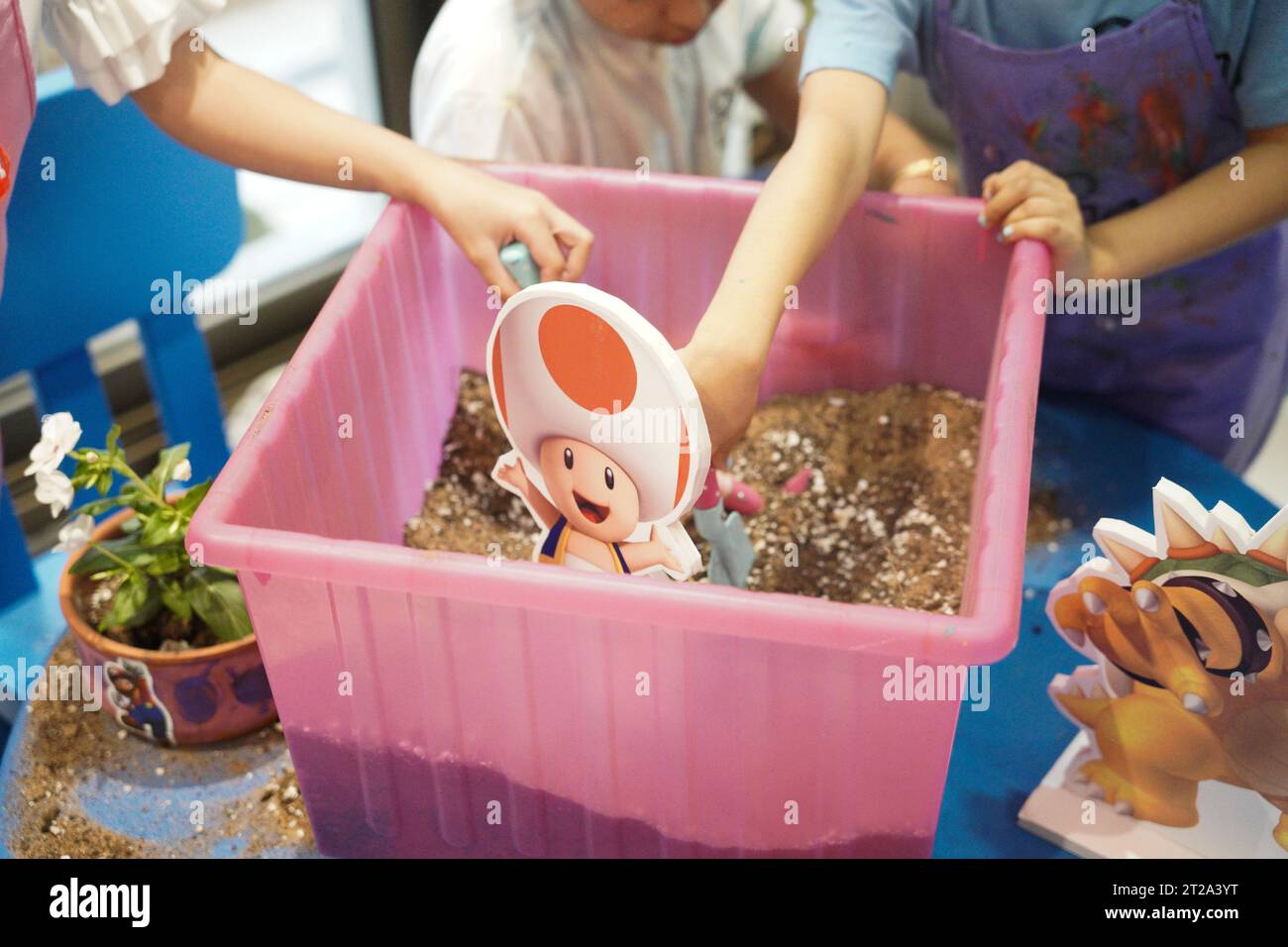 Kids gardening crafts at home. kids gardening a nice flower on a pot ...