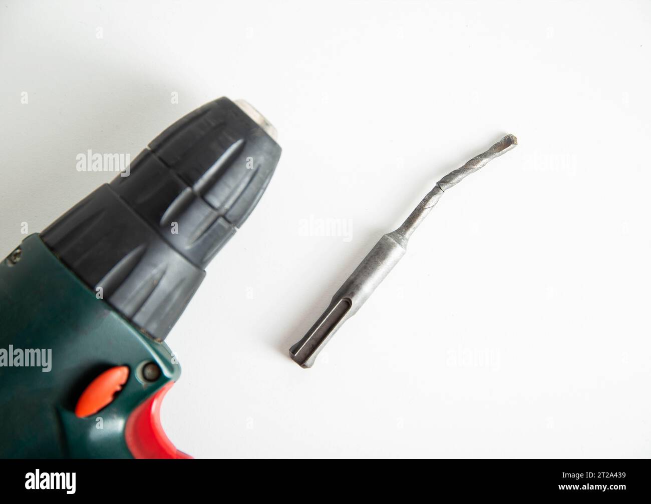 Poor quality broken metal drill on a white background Stock Photo - Alamy
