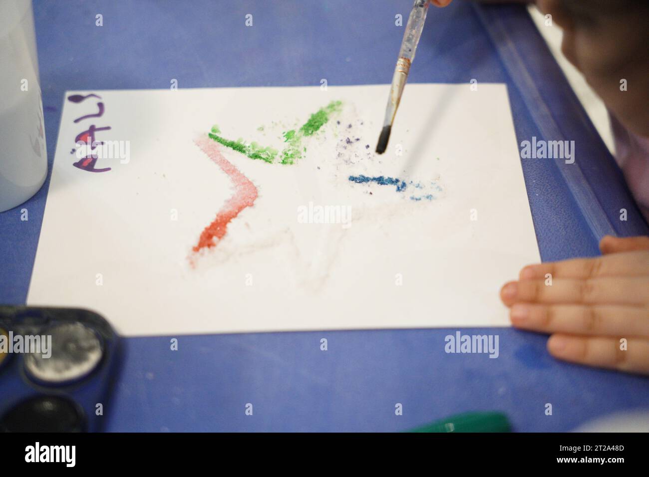 Painting in salt, kids doing art activities at summer camp. star with ...