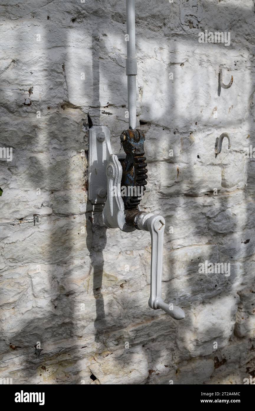 Window winding mechanism on white wall in an old glasshouse Stock Photo ...