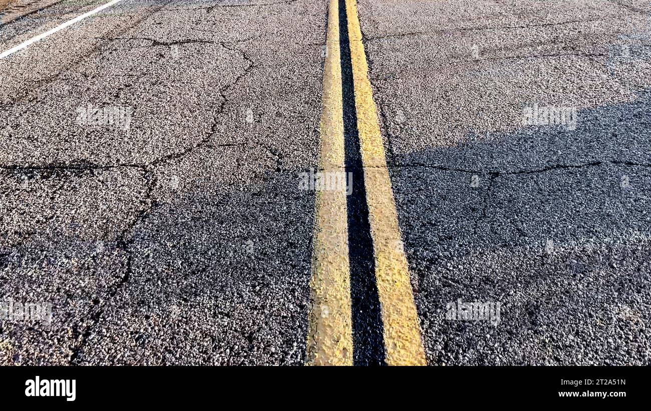 Yellow line of road markings on the road pavement, on the highway that ...