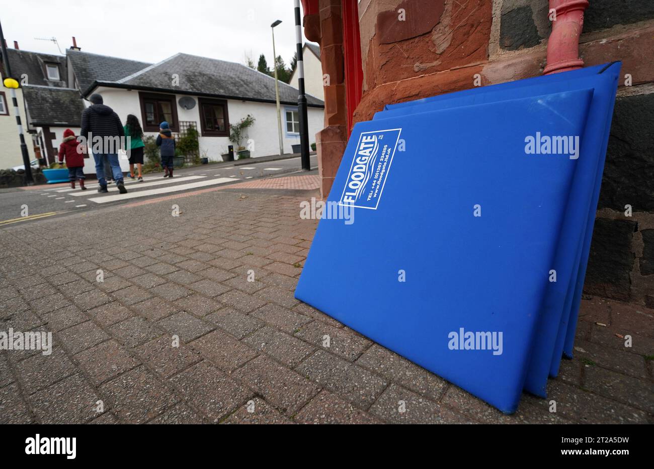 Flood prevention measures sit against a wall in the main street in ...