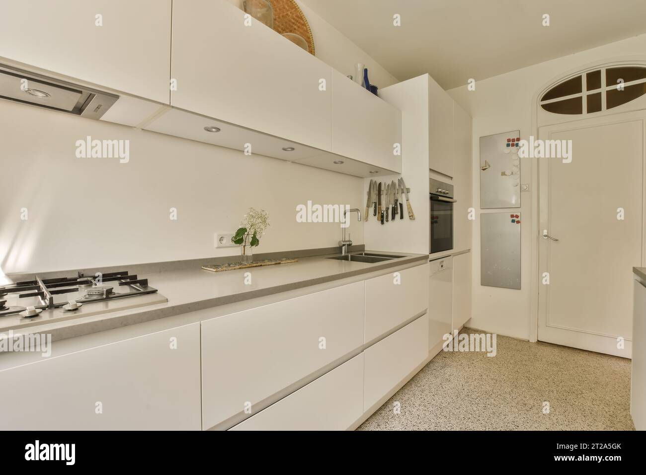 a modern kitchen with white cabinets and counter space in the middle of ...