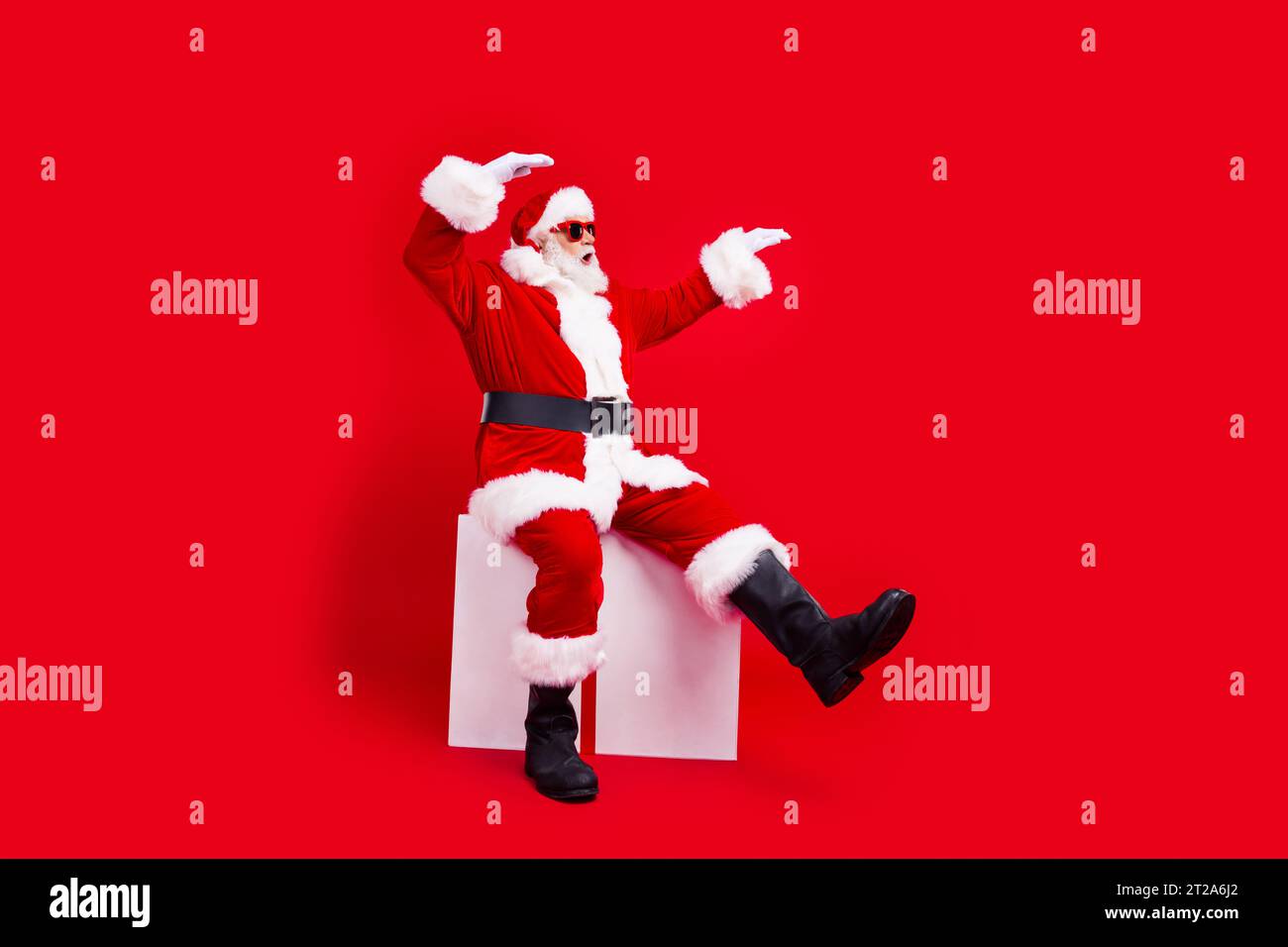 Full length photo of funny crazy santa claus in sunglass sit on white ...