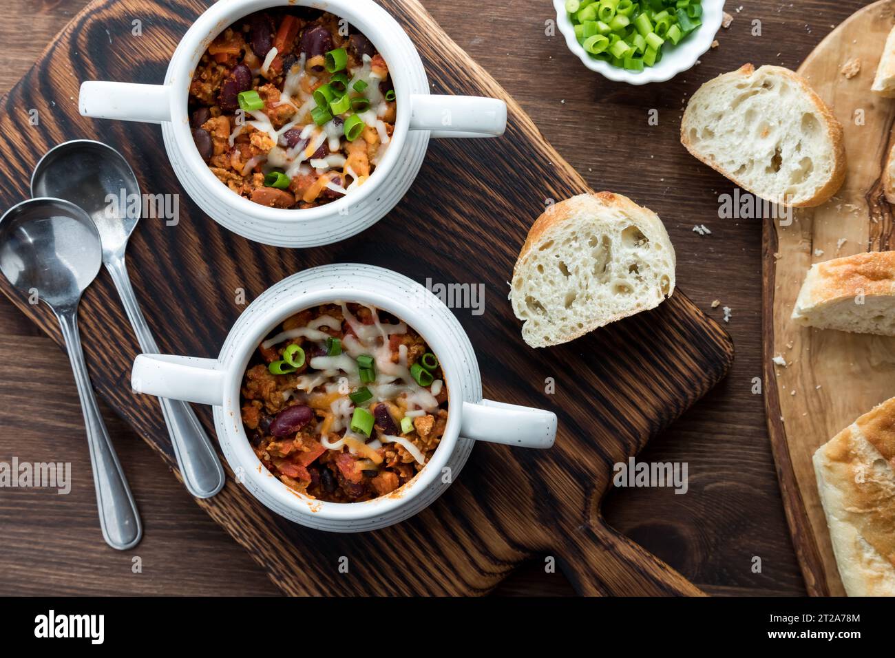 A top down view of crock bowls filled with homemade chili con carne ...