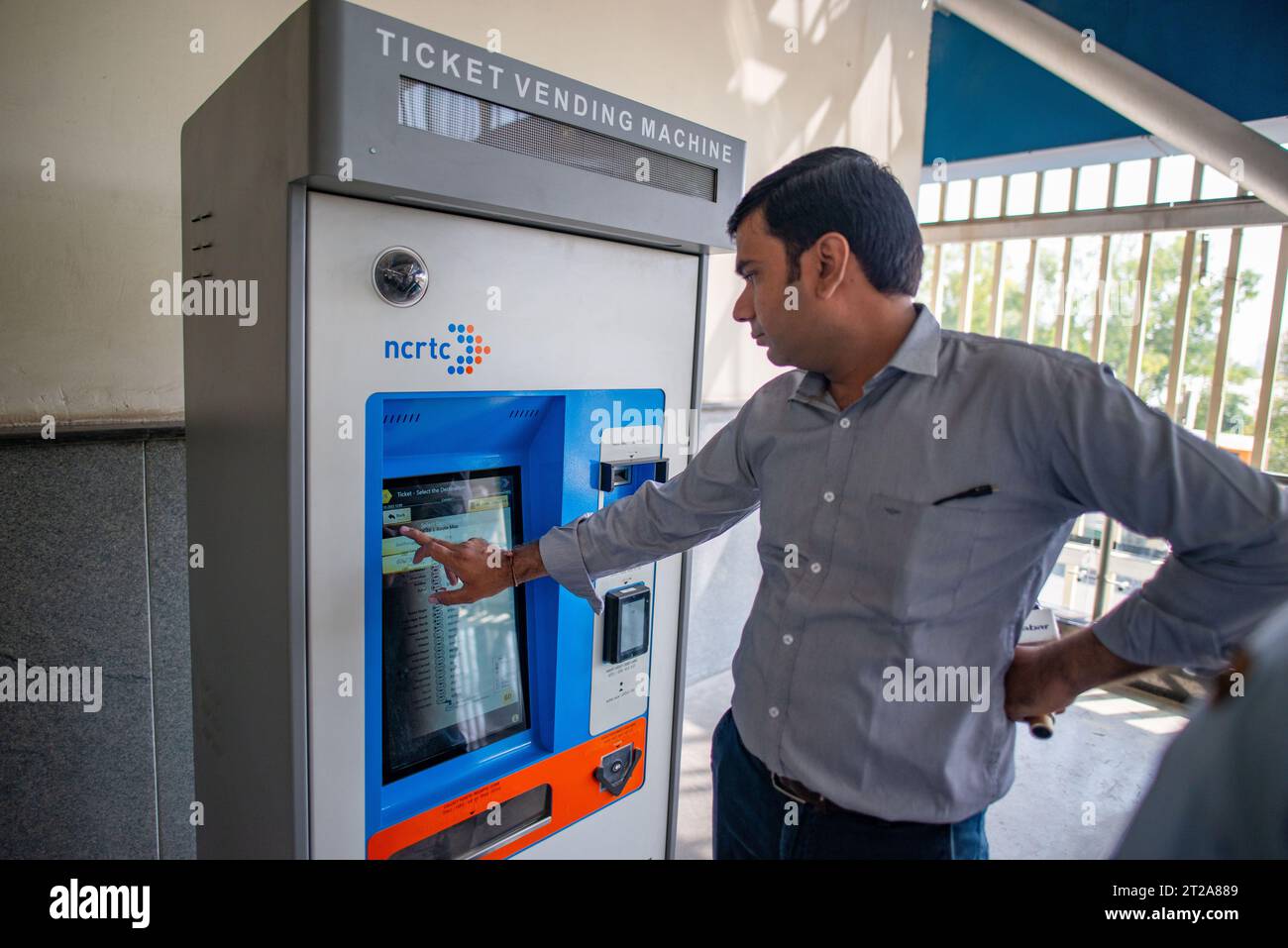 A media person is experiencing the ticket vending machine during a ...