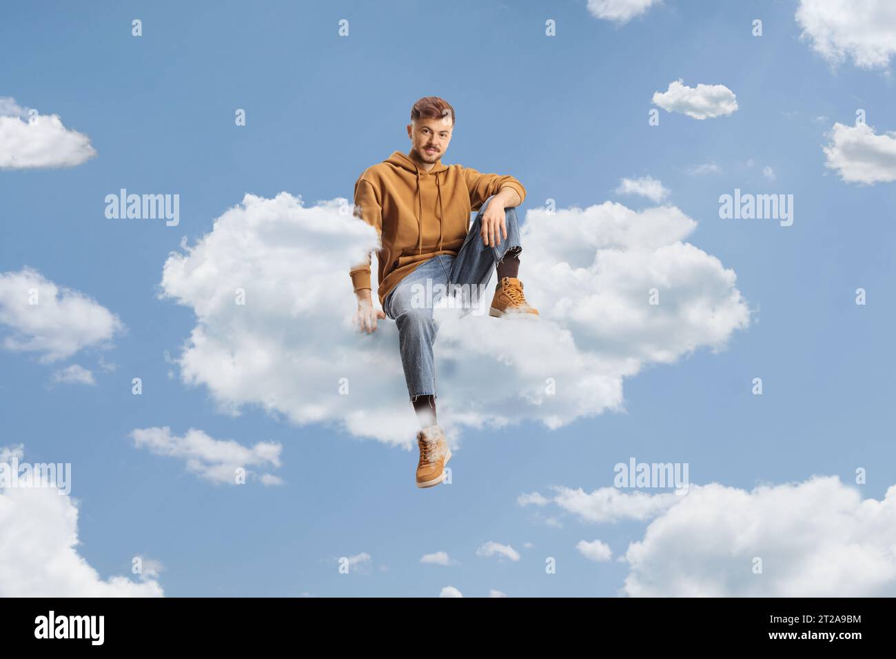 Generation z guy floating on a cloud up in the sky Stock Photo - Alamy