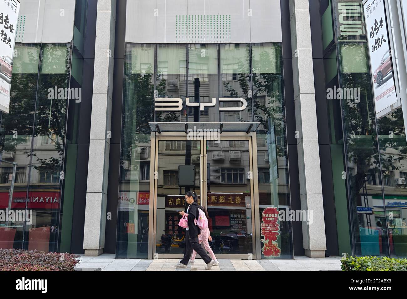 SHANGHAI, CHINA - OCTOBER 18, 2023 - Pedestrians walk past an BYD ...
