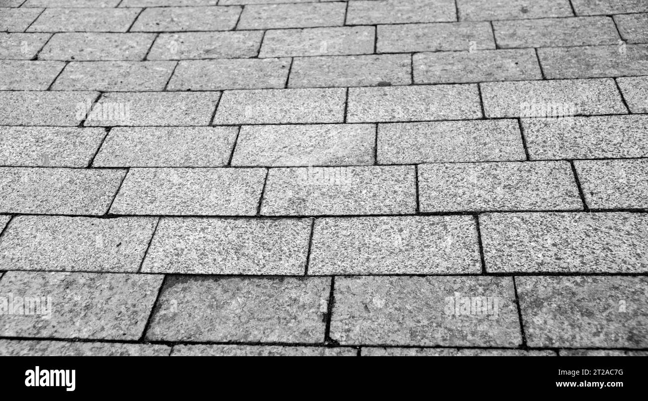 City road pavement made of bricks and stones, road texture in detail ...