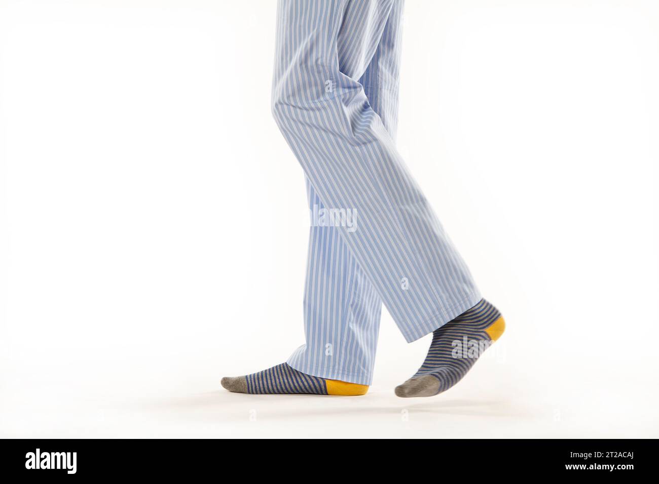 Man wearing a pajama. Legs detail over a white background Stock Photo ...