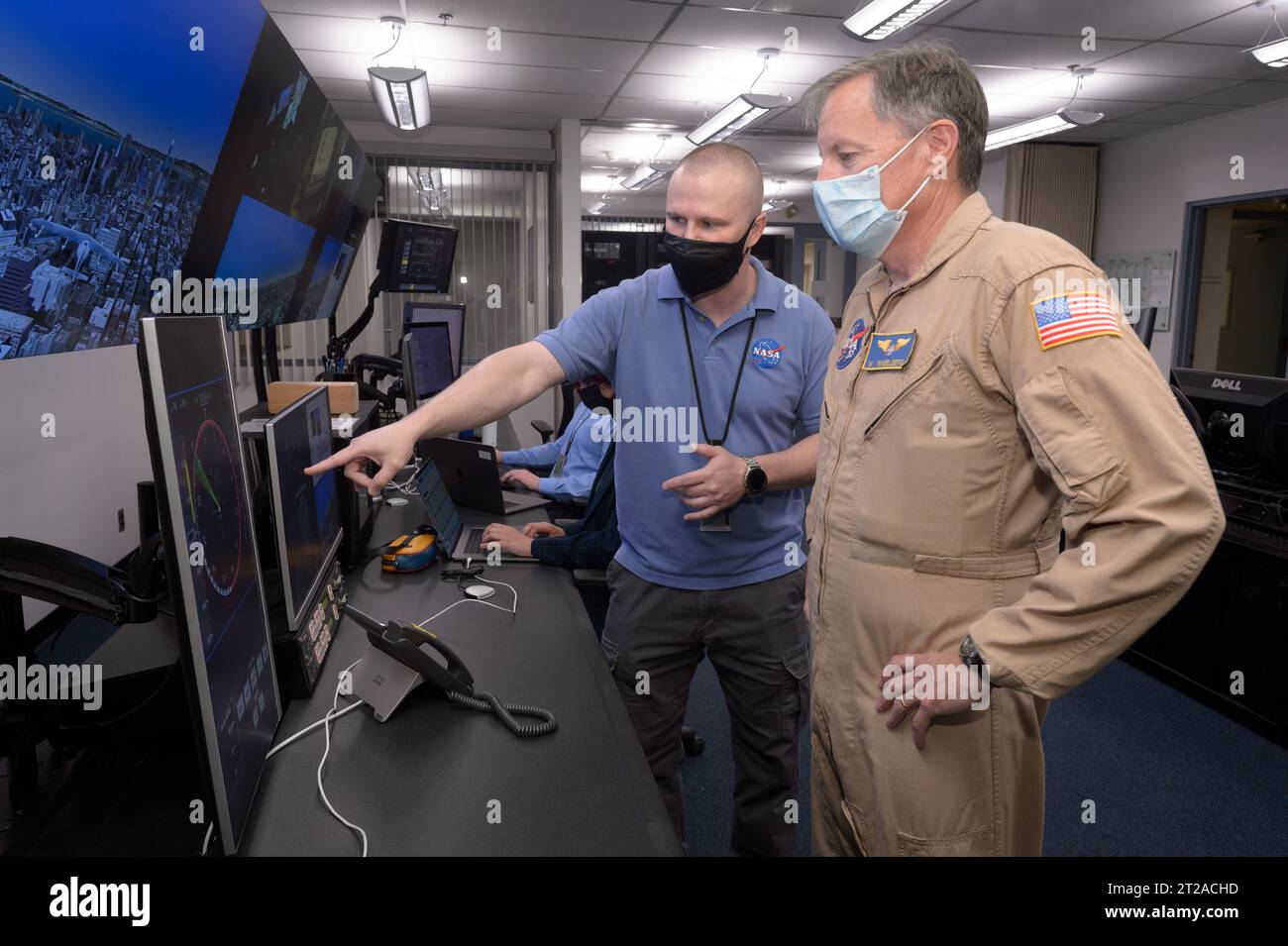 Casey Smith, human factors engineer, and pilot Wayne Ringelberg review ...