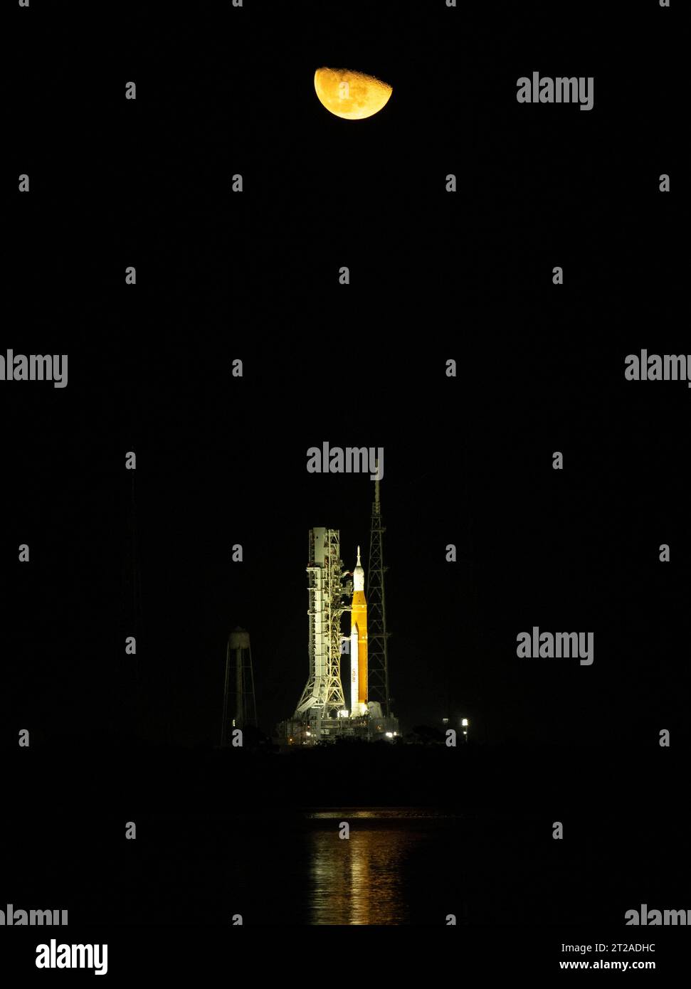 Artemis I Prelaunch. The Moon is seen rising above NASA’s Space Launch System (SLS) rocket with ...