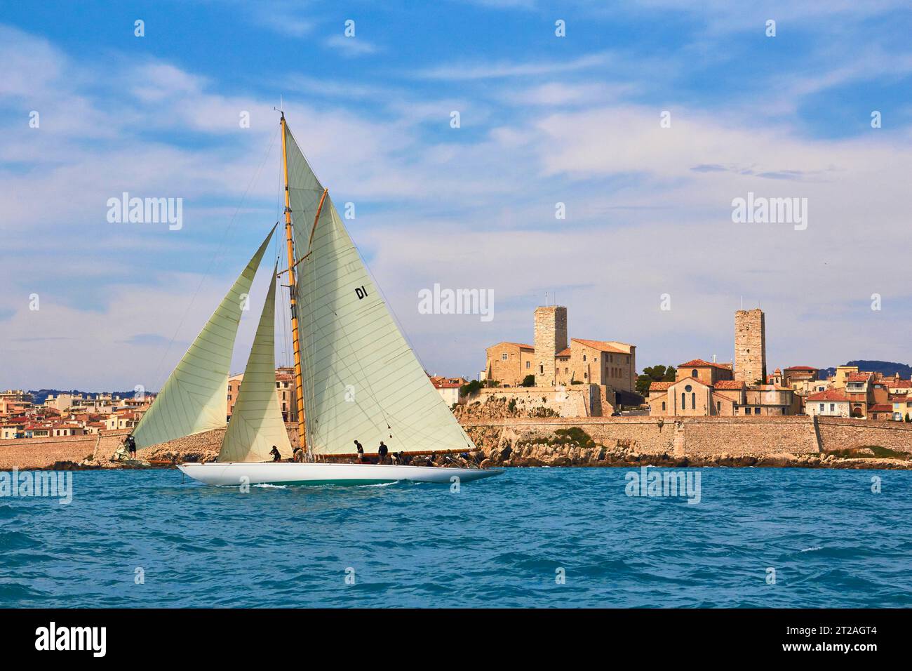 A view from the sea of the old town of Antibes with the classic sailing ...