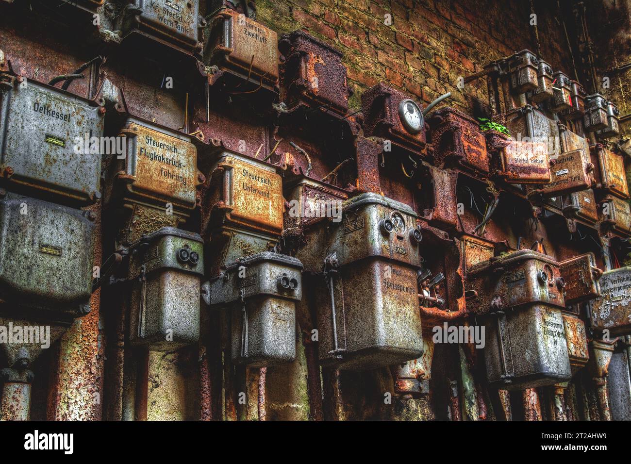 An industrial rust-covered wall featuring a variety of electrical ...