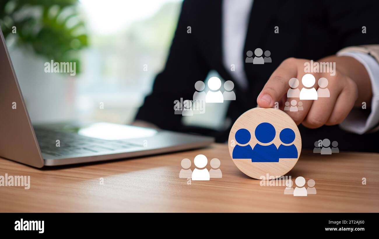 Businessman points finger at circular wooden plank to select business ...