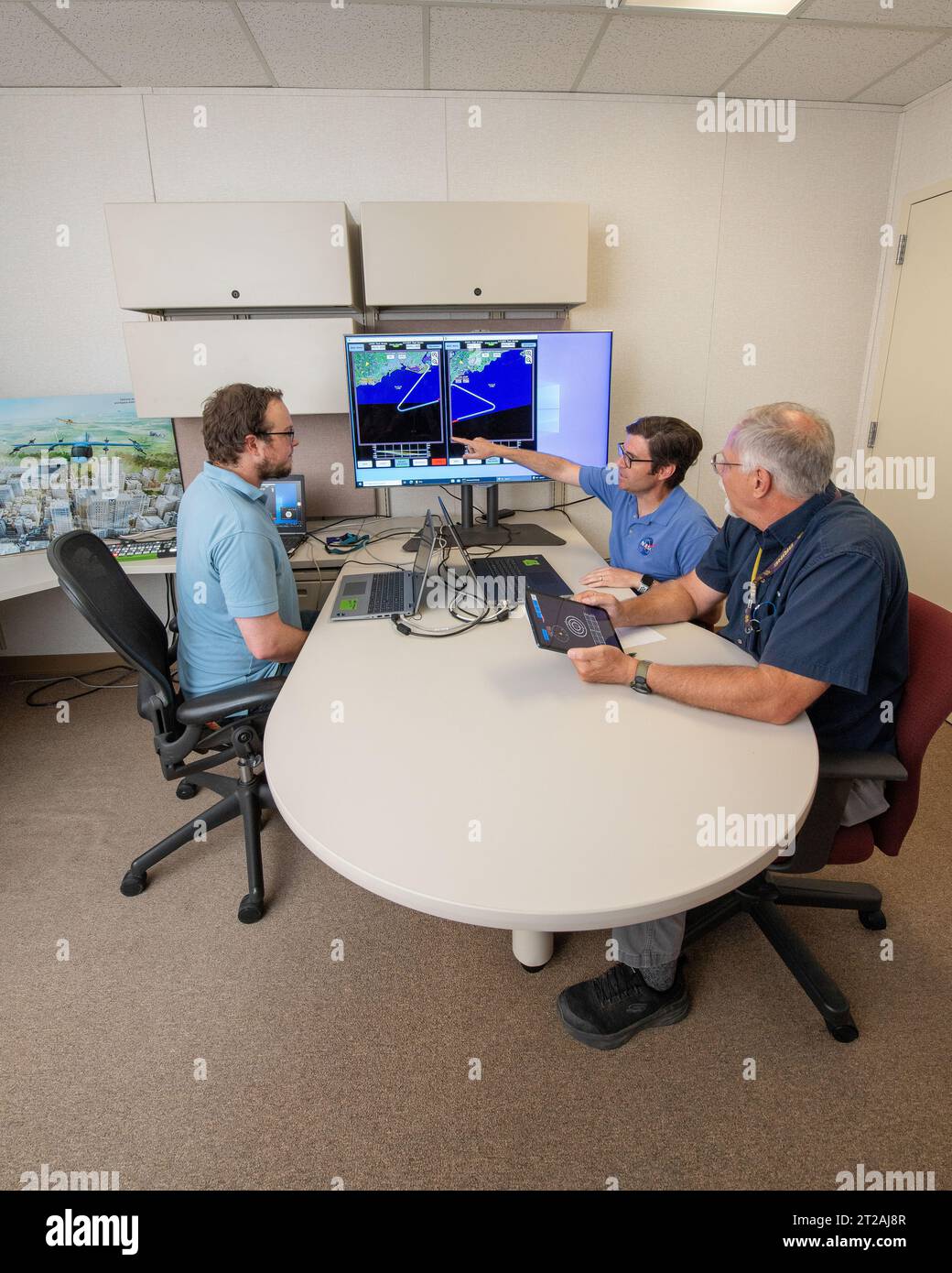 . NASA software developer, Ethan Williams, left, pilot Scott Howe, and ...