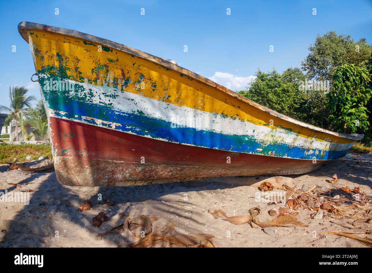 A colorful rustic boat resting on a lonely beach Stock Photo - Alamy