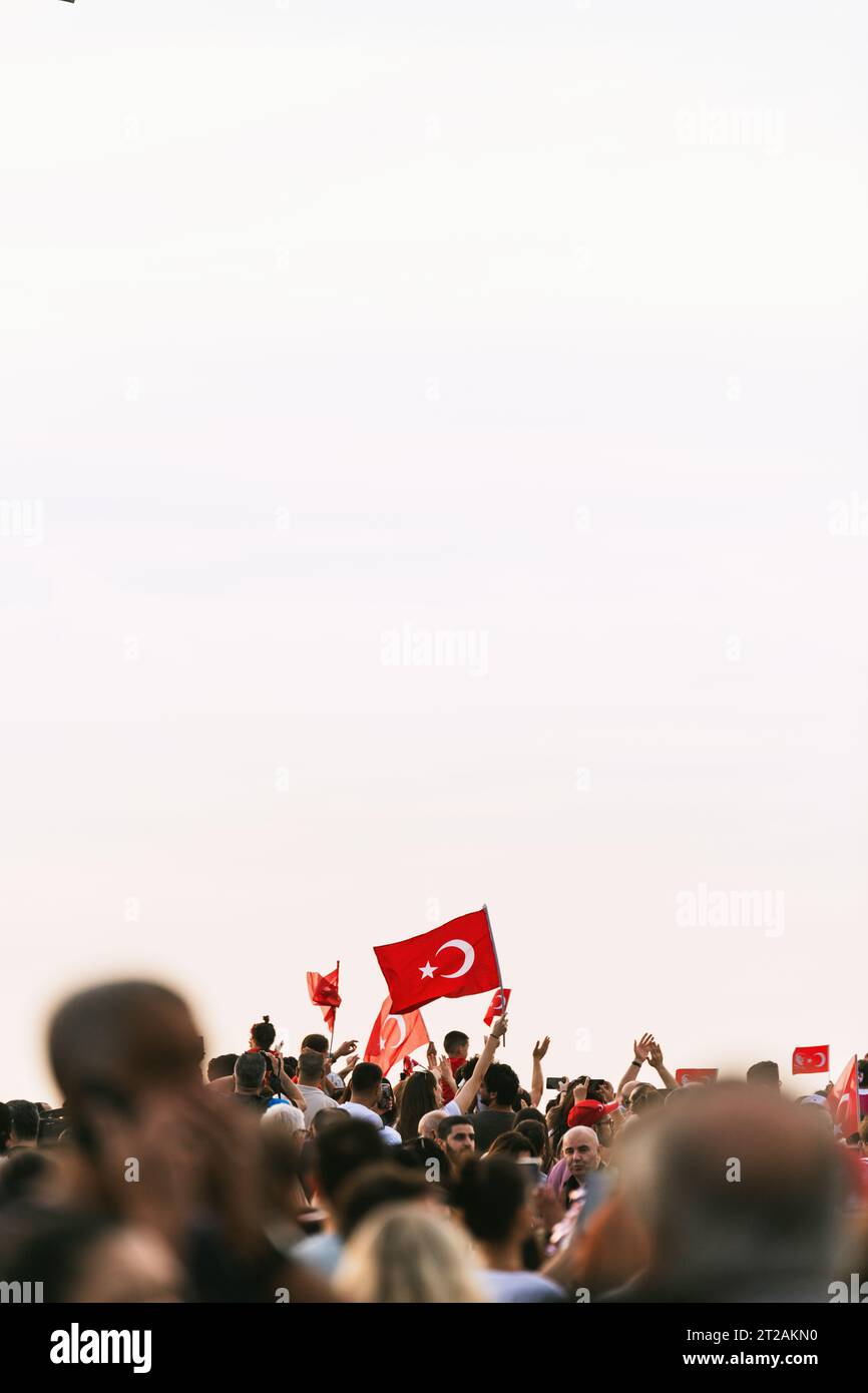 Izmir, Turkey - September 9, 2023: A jubilant crowd waves multiple ...